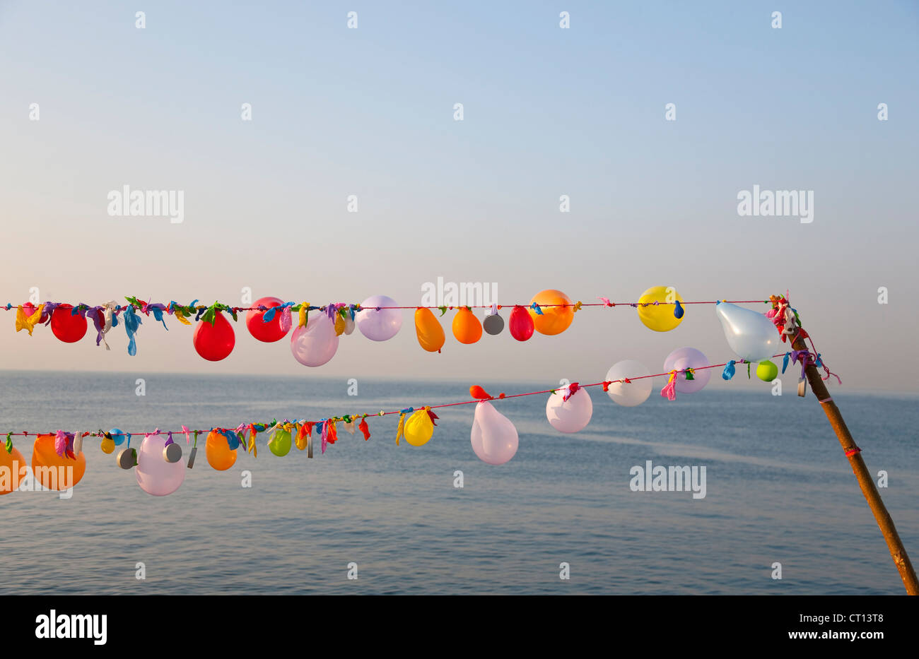 String of balloons floating in wind Stock Photo - Alamy
