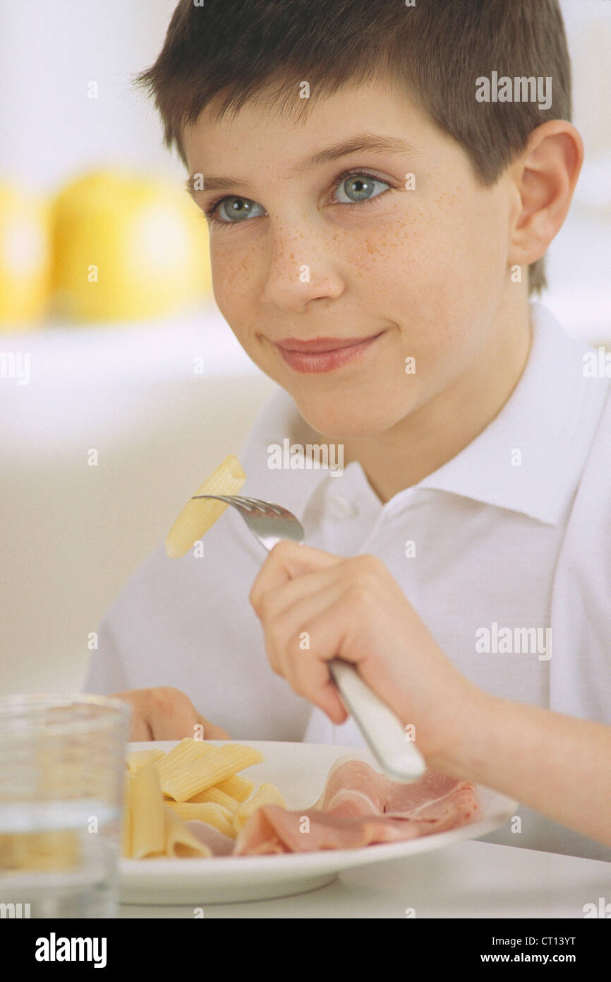 CHILD EATING STARCHY FOOD Stock Photo - Alamy