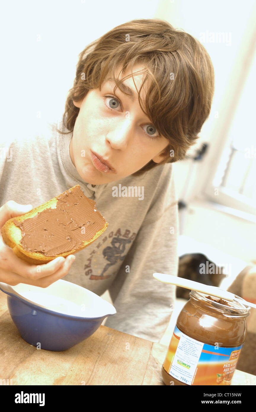 ADOLESCENT EATING BREAKFAST Stock Photo - Alamy