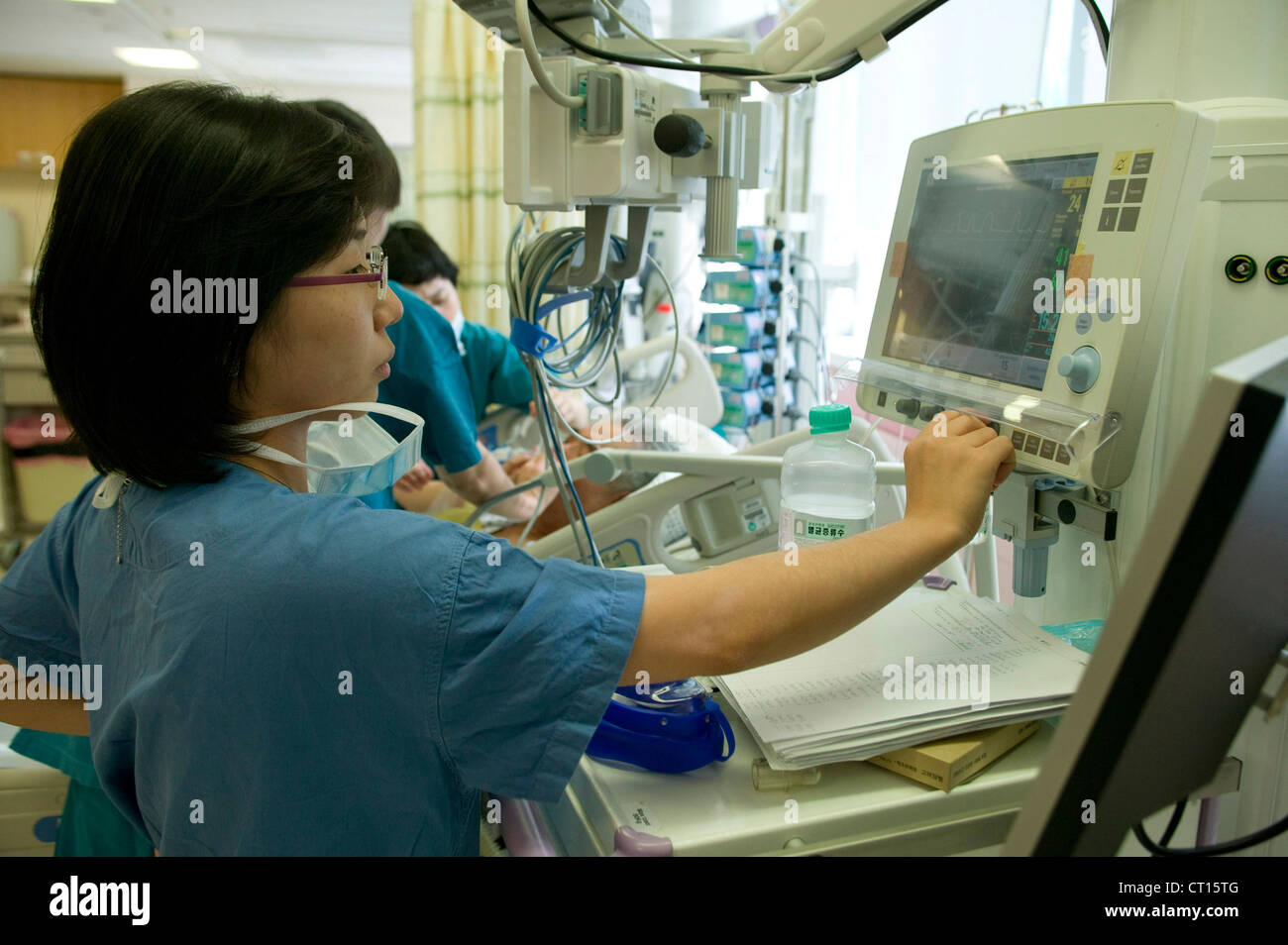 A nurse checks an ecg monitor in an intensive care unit Stock Photo - Alamy