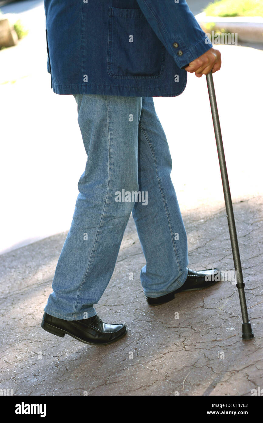 ELDERLY PERSON OUTDOORS W. CANE Stock Photo - Alamy
