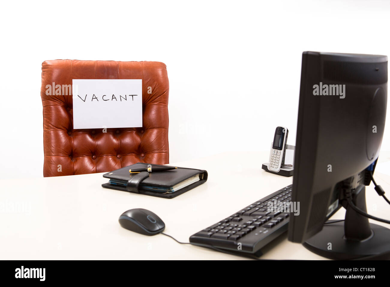 Executive office desk with an employment opportunity sign on leather ...