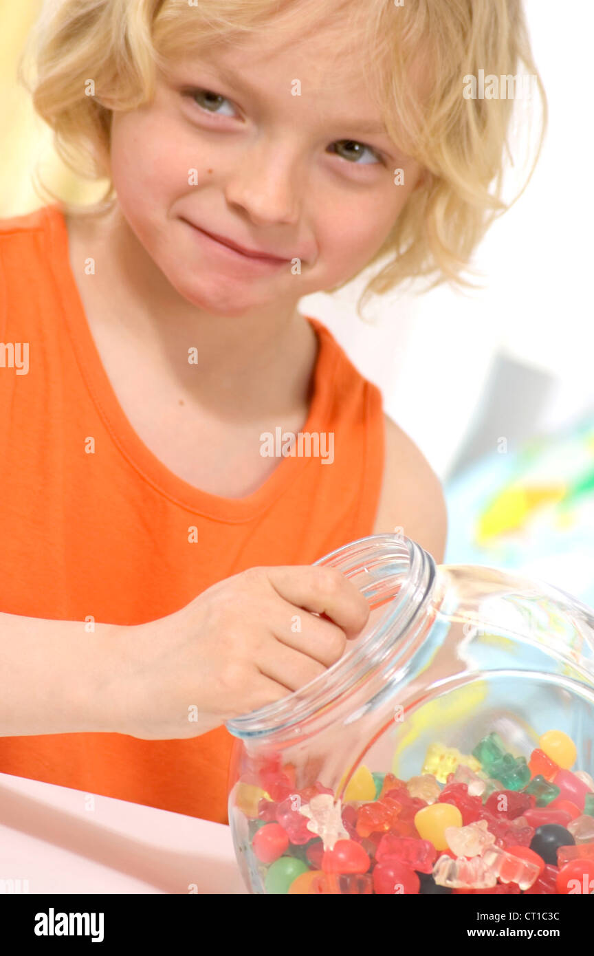 CHILD EATING SWEETS Stock Photo - Alamy