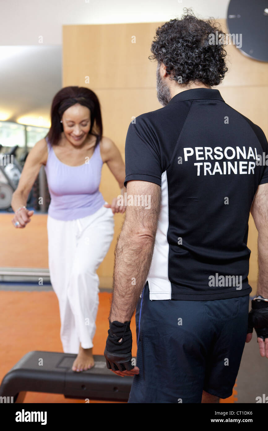 Female trainer assisting senior hi-res stock photography and images - Alamy