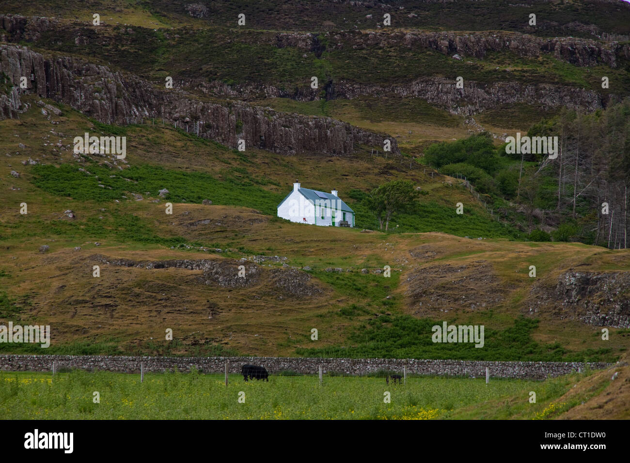 A small white traditional croft house, now a self-catering cottage, on ...