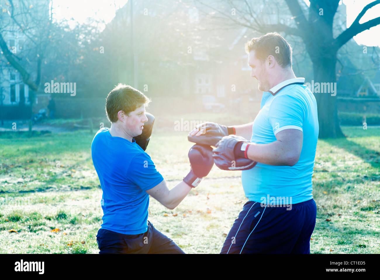 Boxer training with coach outdoors Stock Photo - Alamy
