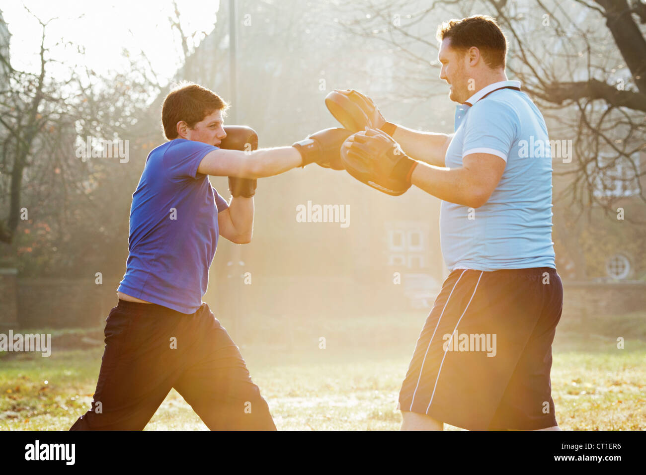Boxer training with coach outdoors Stock Photo - Alamy