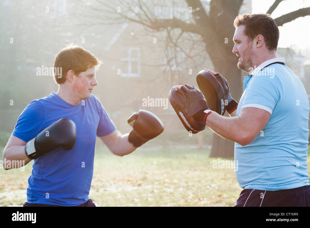Boxer training with coach outdoors Stock Photo - Alamy