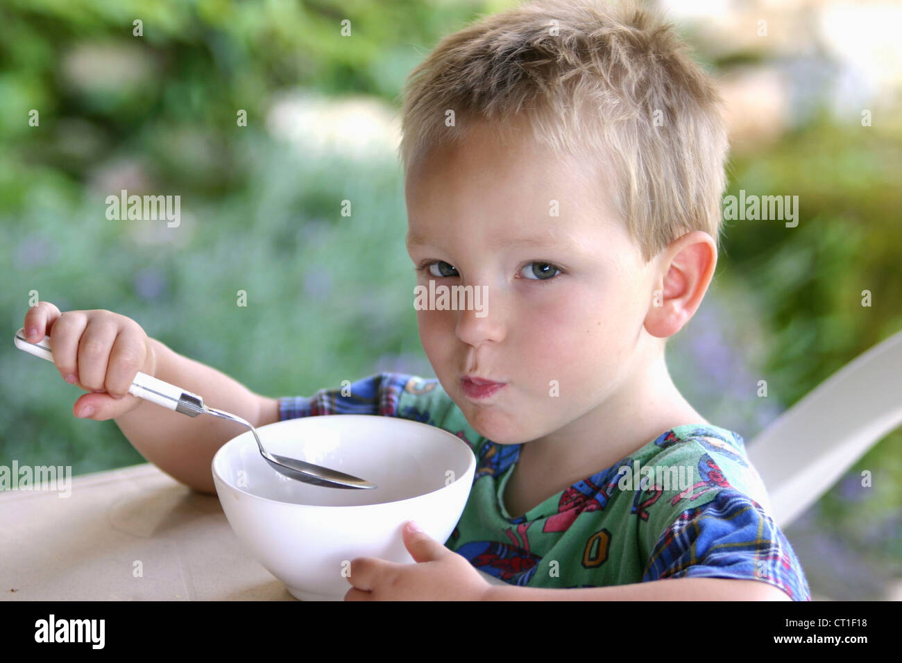 CHILD EATING BREAKFAST Stock Photo - Alamy