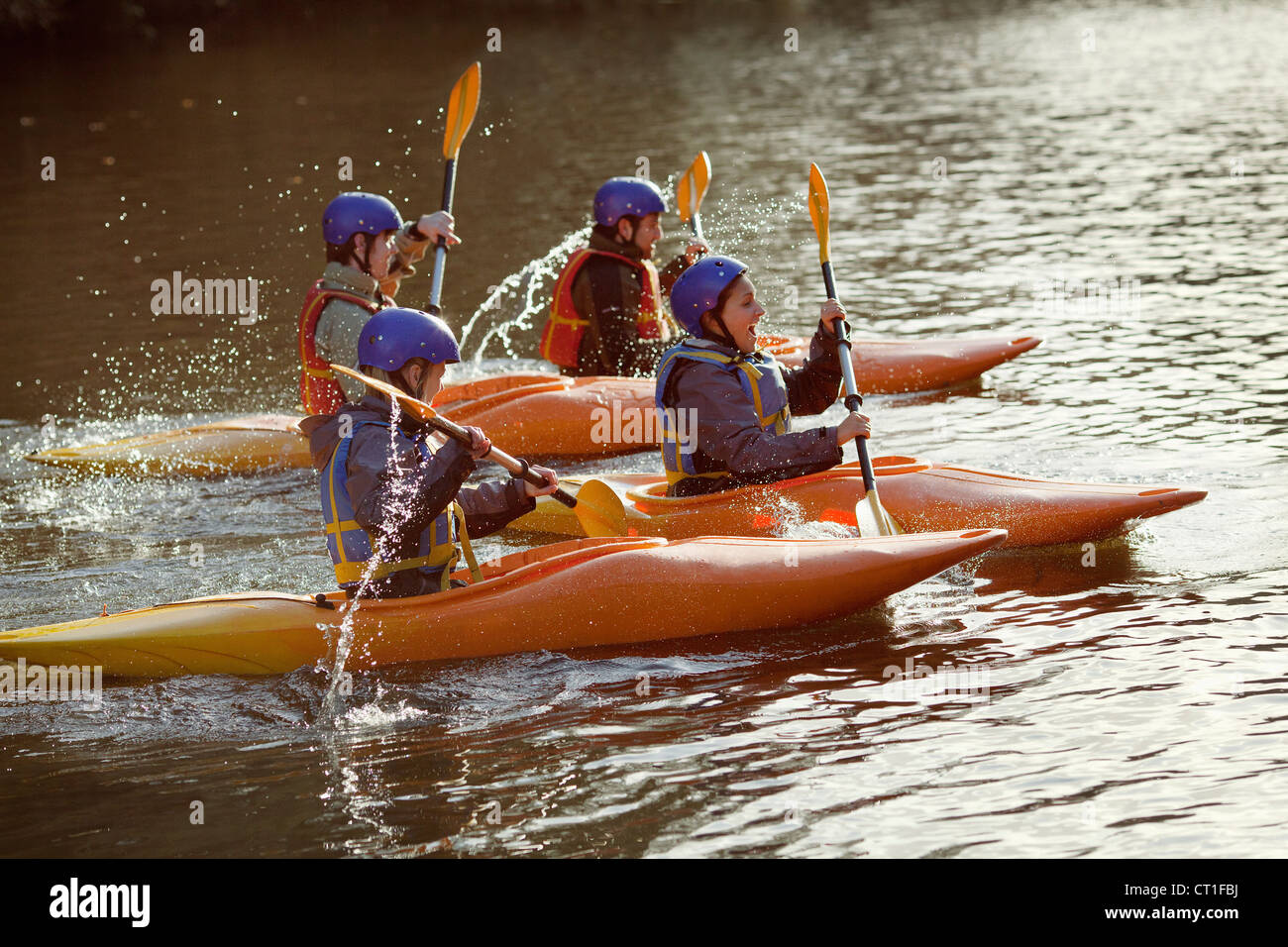 Kayakers rowing together on still lake Stock Photo - Alamy