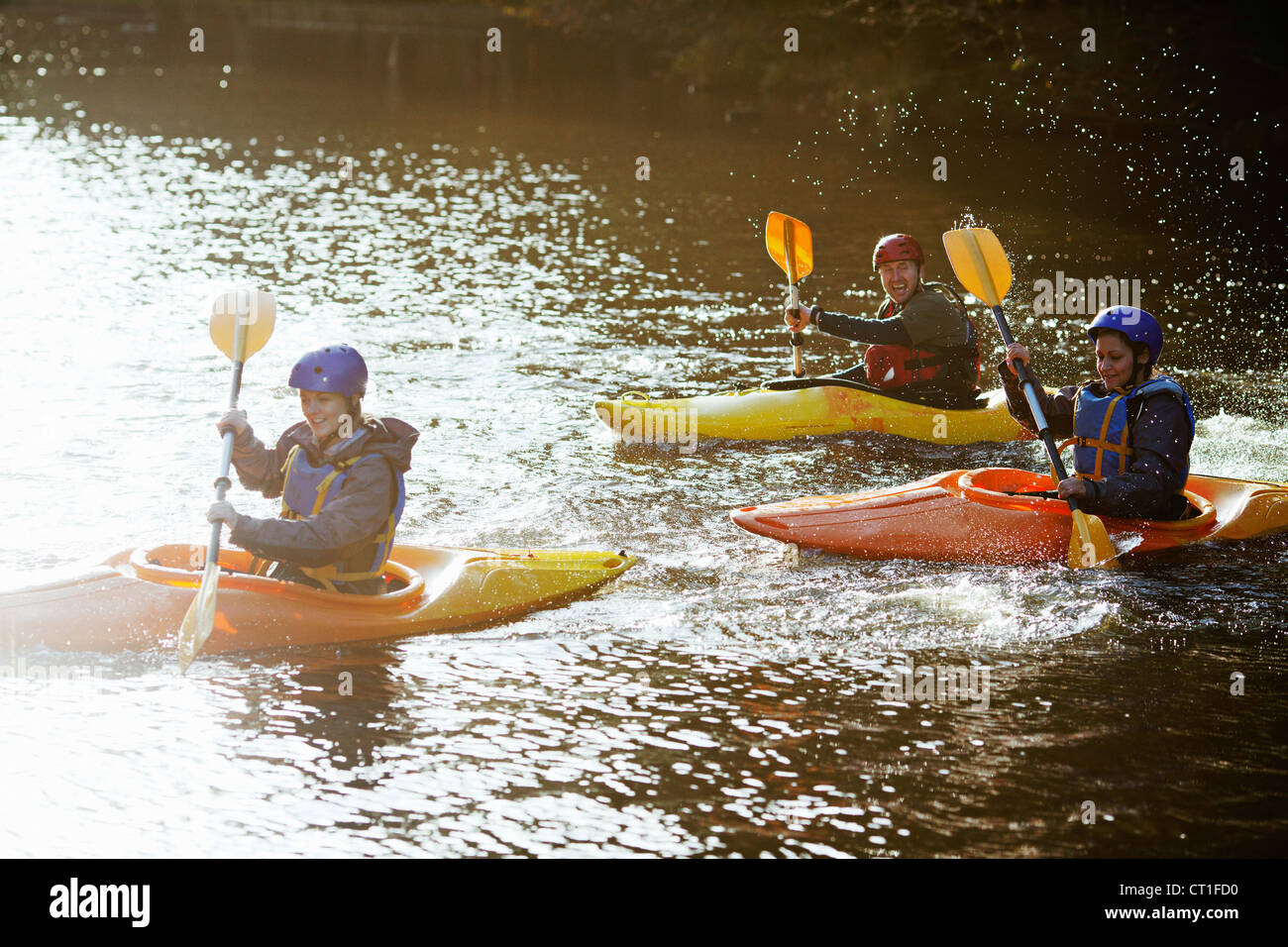 Kayakers rowing together on still lake Stock Photo - Alamy