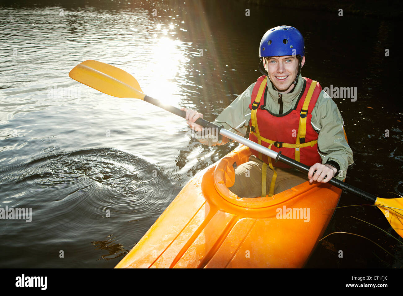Kayaker rowing in still lake Stock Photo - Alamy