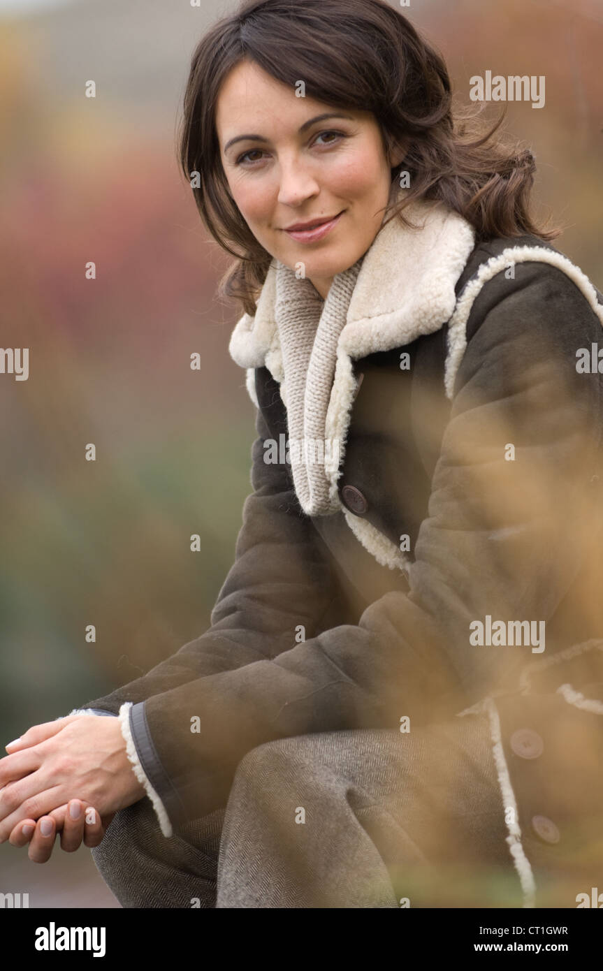 Seated smiling exterior hi-res stock photography and images - Alamy