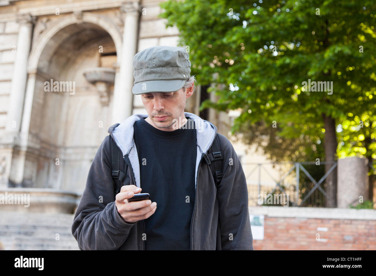 Man using cell phone on city street Stock Photo - Alamy