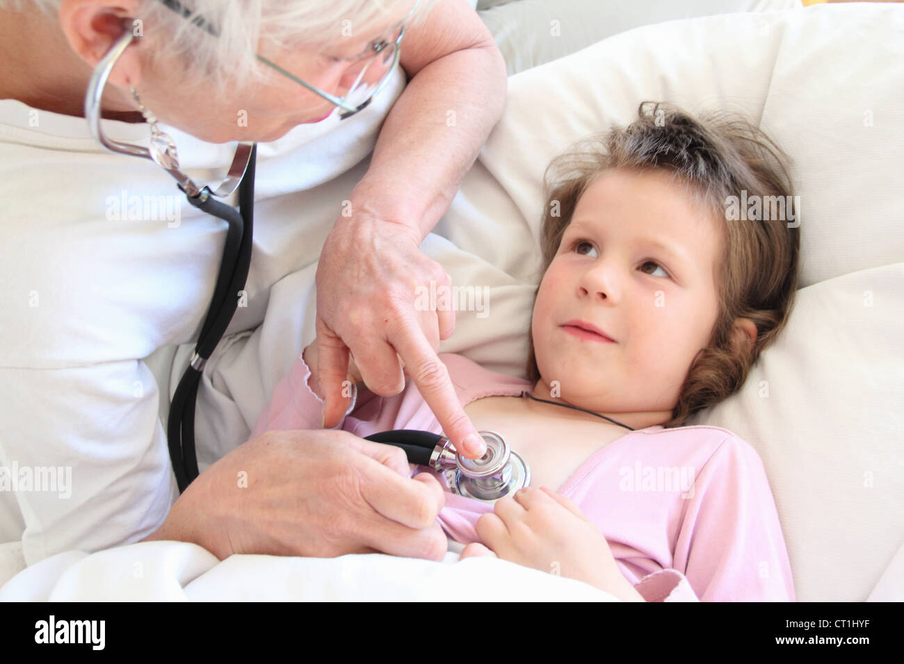 Woman listening to girls heartbeat Stock Photo - Alamy