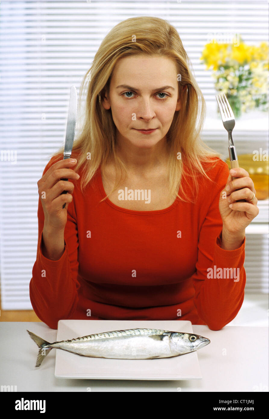 WOMAN EATING FISH Stock Photo - Alamy