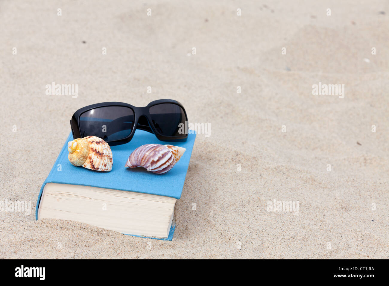 Read and relax on a sandy beach Stock Photo - Alamy