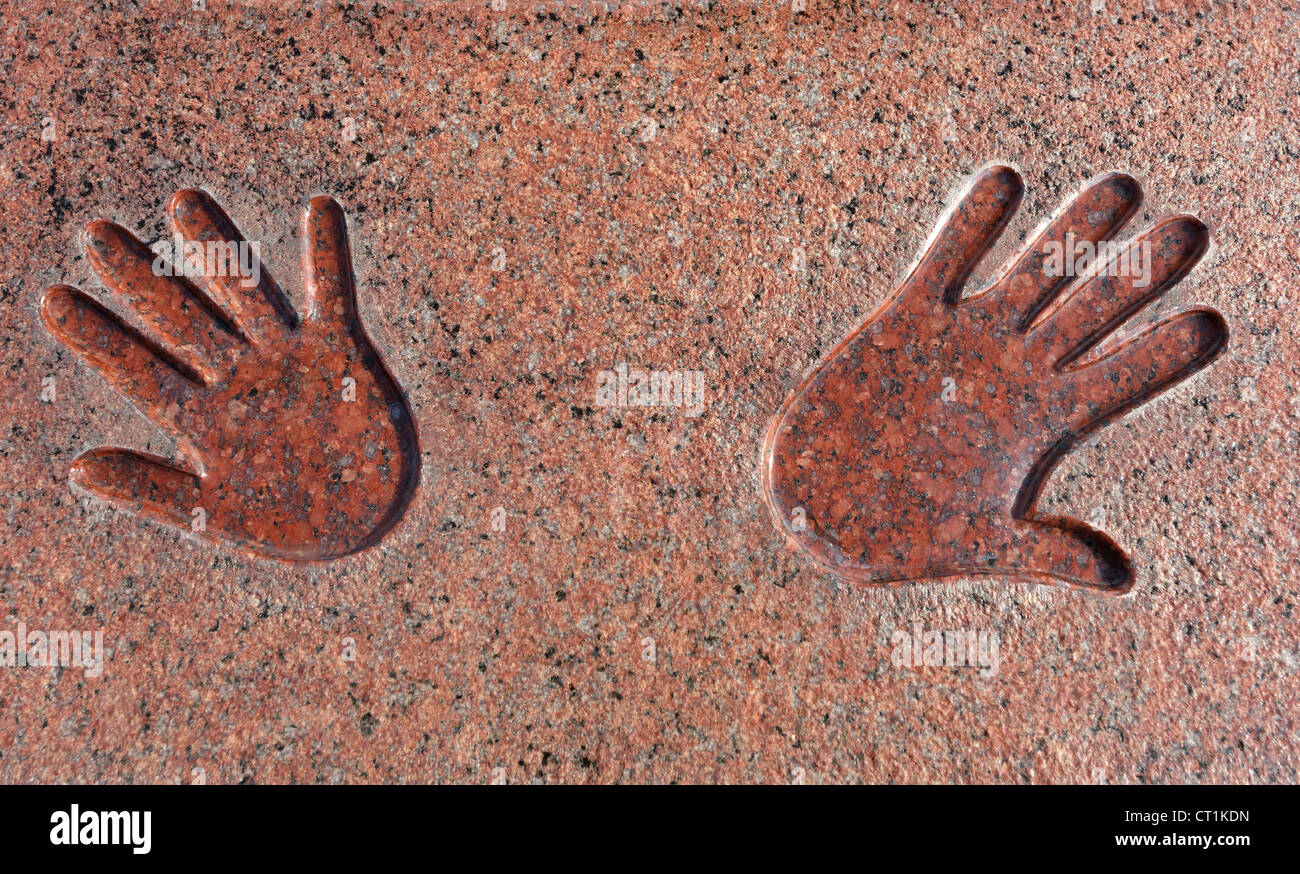 human hand prints in red marble Stock Photo - Alamy
