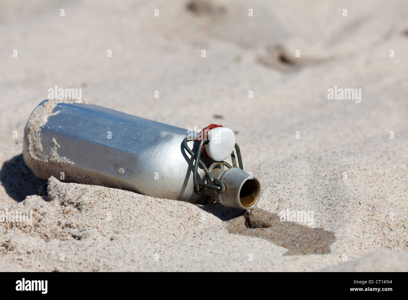 Leaking Canteen in the desert Stock Photo - Alamy