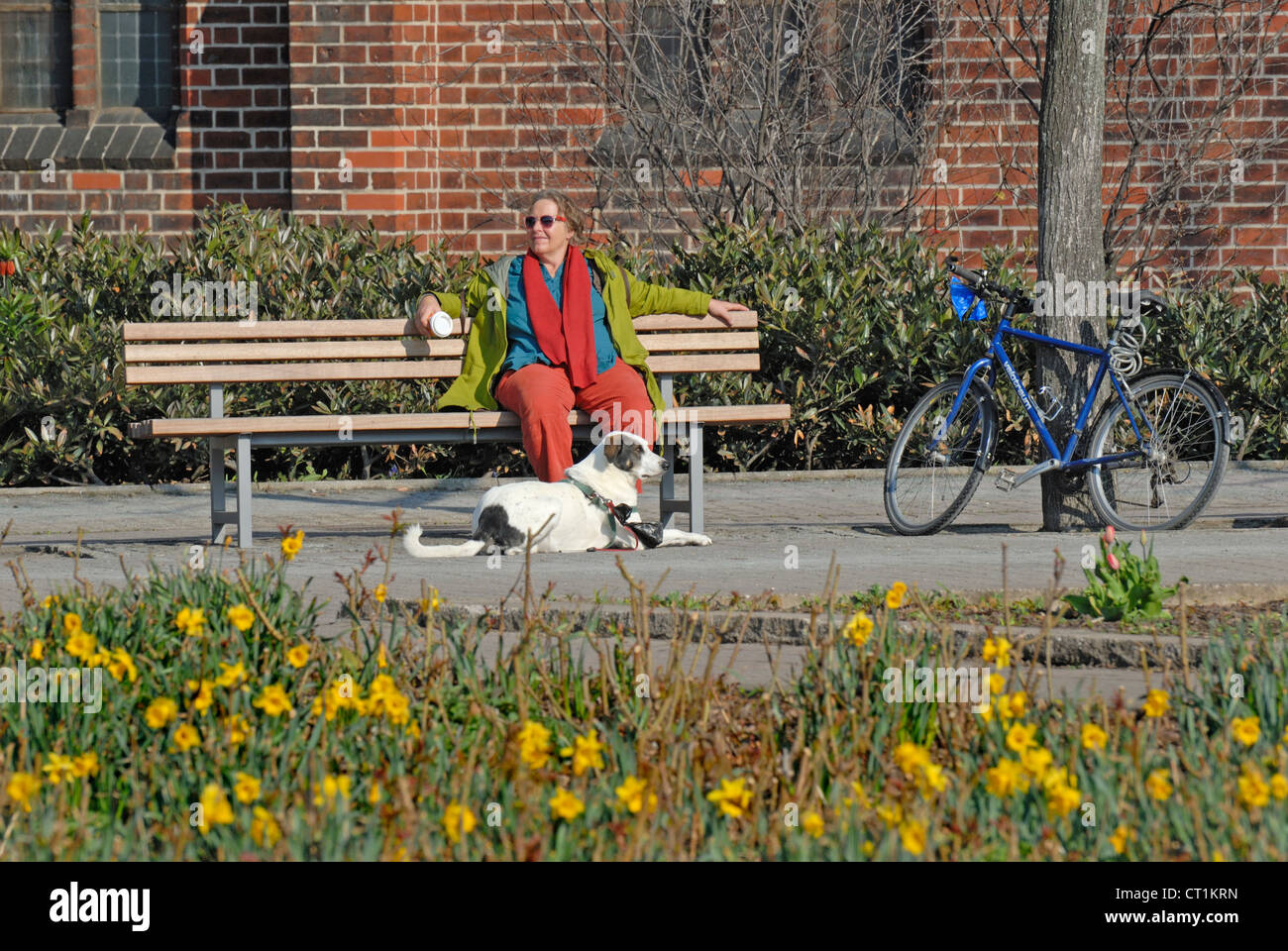 Berlin, Germany. Woman with bike and dog sitting in front of the ...