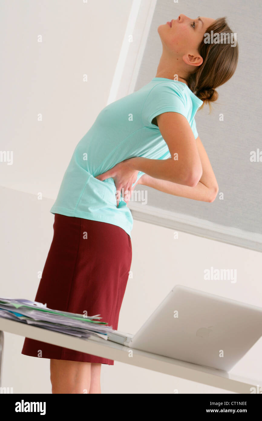 LOWER BACK PAIN IN A WOMAN Stock Photo - Alamy