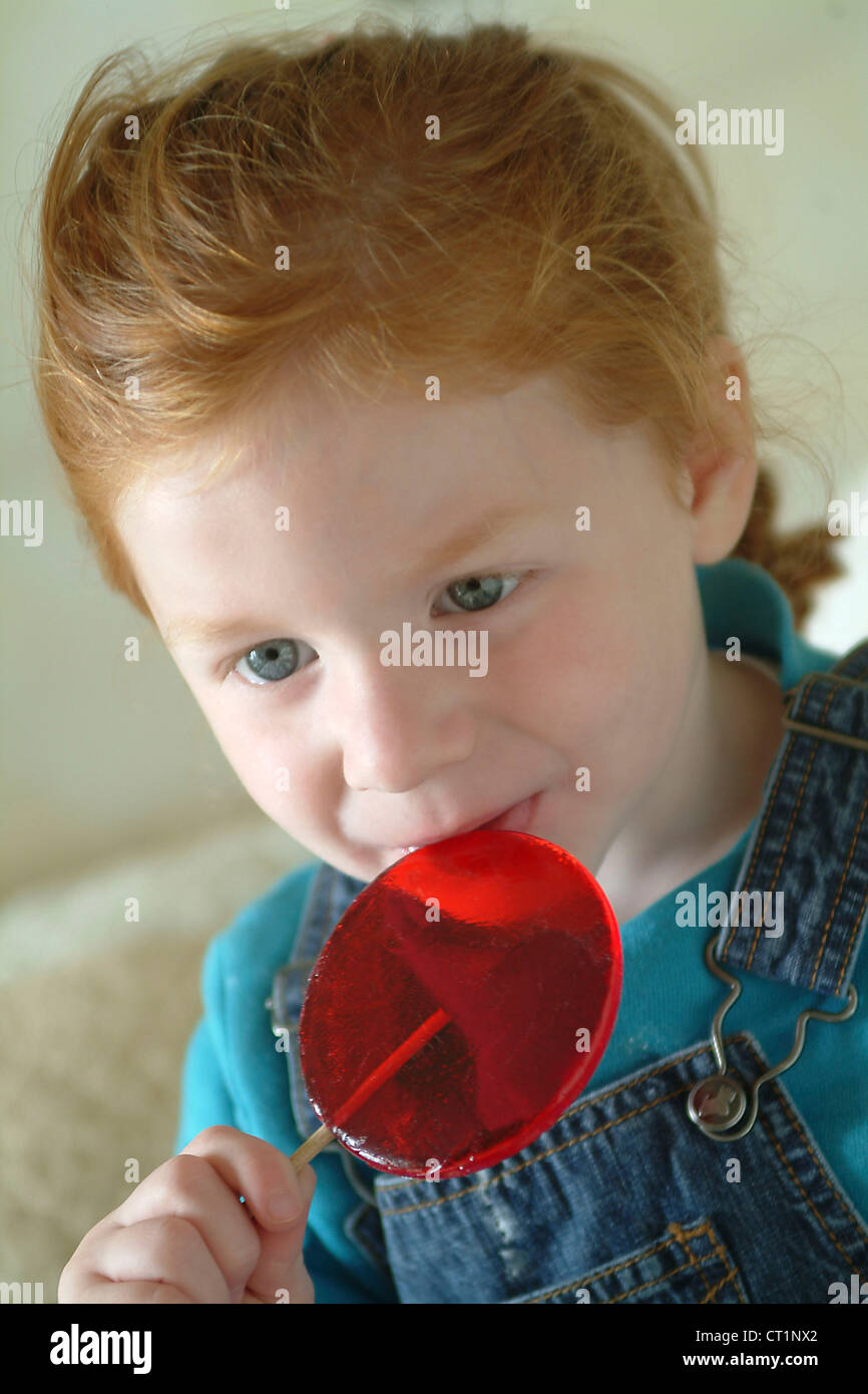 CHILD EATING SWEETS Stock Photo - Alamy