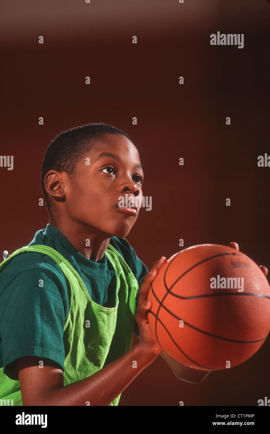 Young African American boy shooting the basketball Stock Photo - Alamy