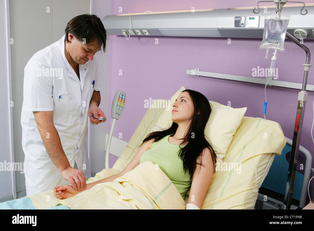 TAKING A WOMAN'S PULSE Stock Photo - Alamy
