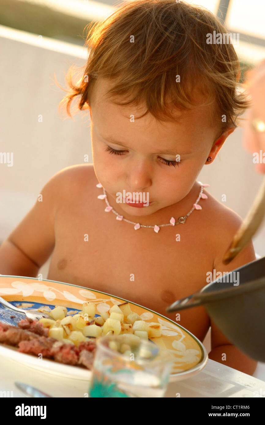 CHILD EATING MEAT Stock Photo - Alamy