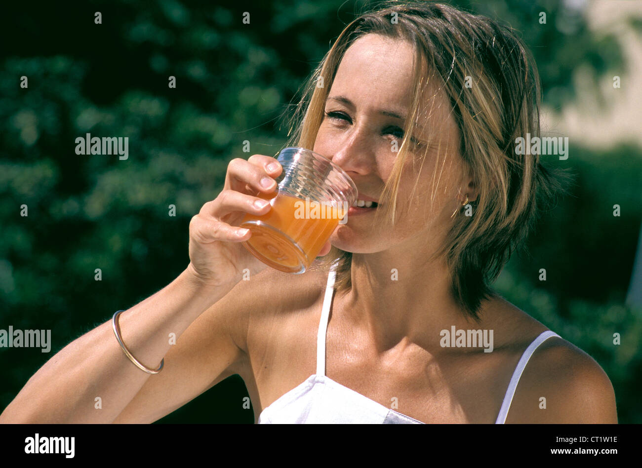 WOMAN WITH COLD DRINK Stock Photo - Alamy