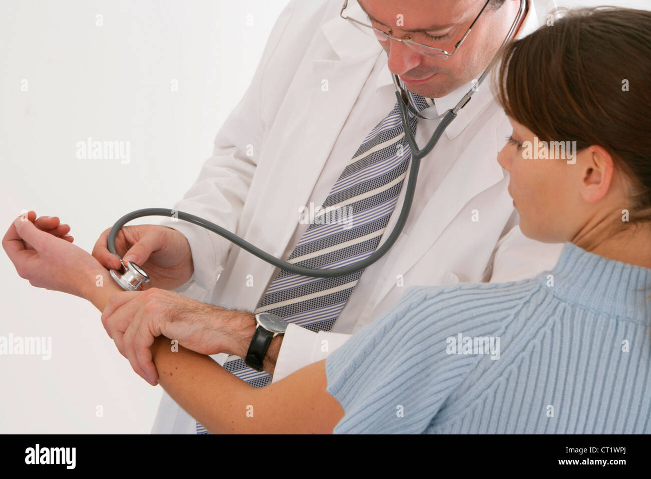 TAKING A WOMAN'S PULSE Stock Photo - Alamy
