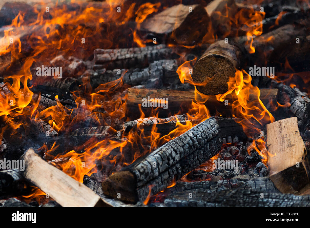 Burning Log and red Flame Stock Photo - Alamy