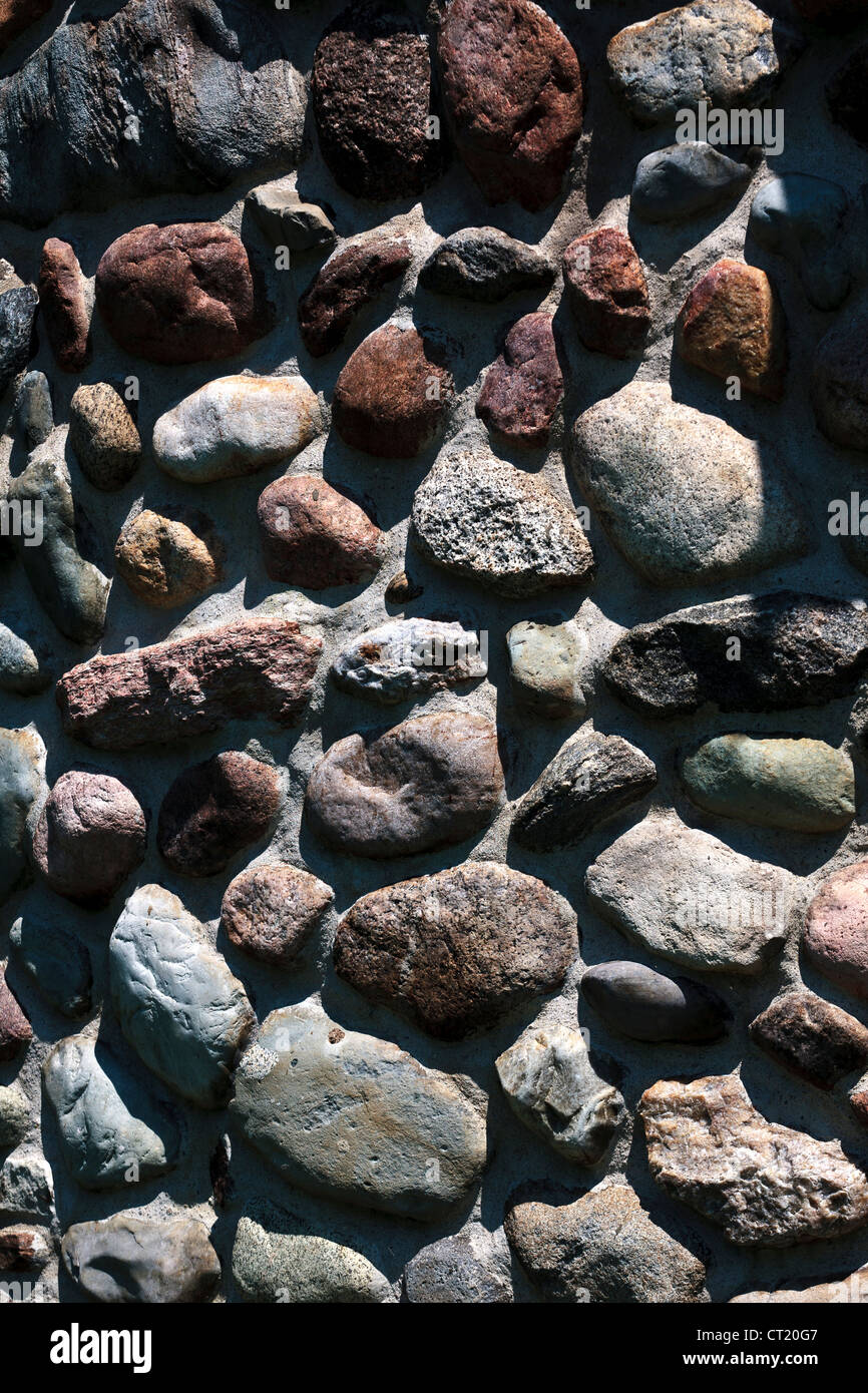 Stones set in concrete Stock Photo - Alamy