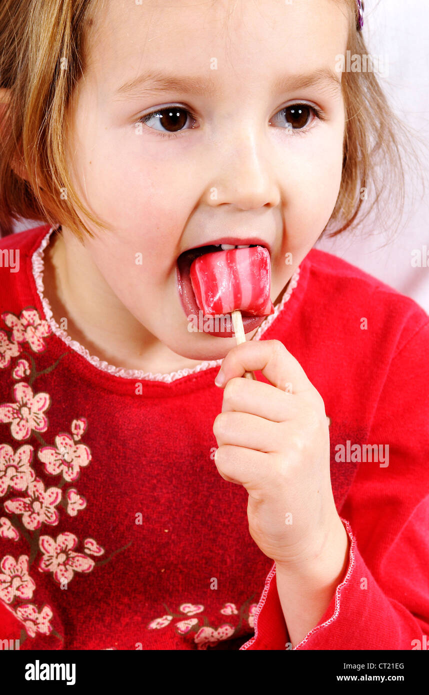 CHILD EATING SWEETS Stock Photo - Alamy