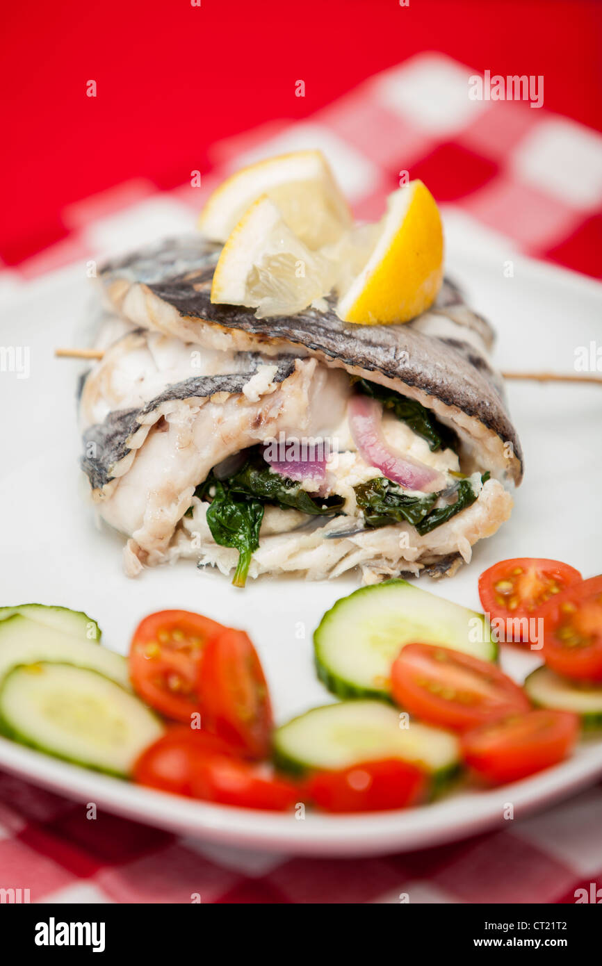 Steamed blue grenadier fish filled with spinach, red onion and feta on ...