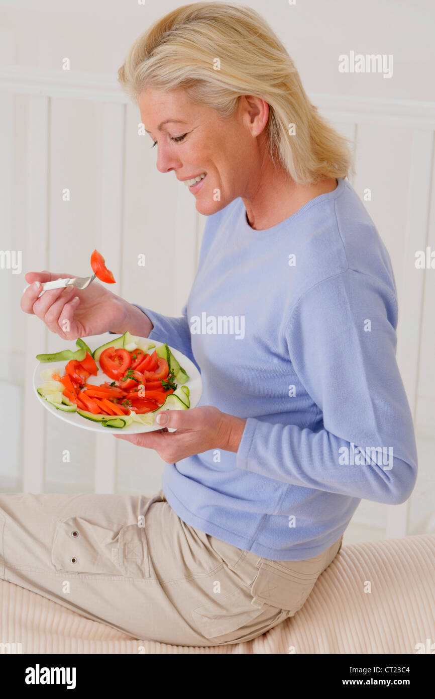 ELDERLY P. EATING RAW VEGETABLES Stock Photo - Alamy