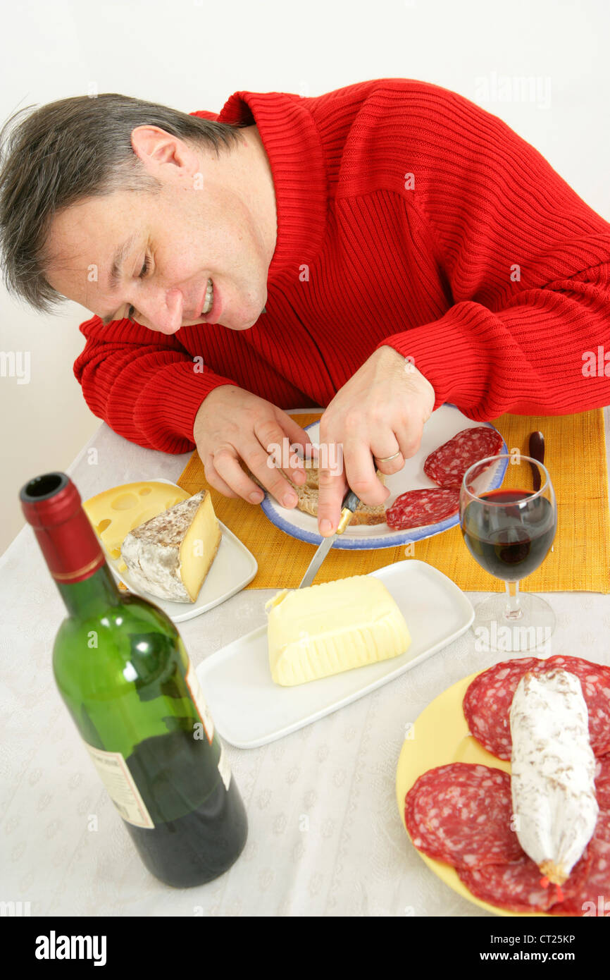 MAN EATING PORK MEAT Stock Photo - Alamy