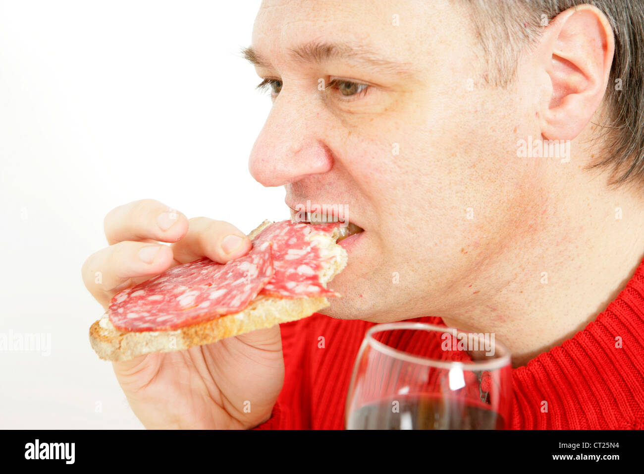 MAN EATING PORK MEAT Stock Photo - Alamy