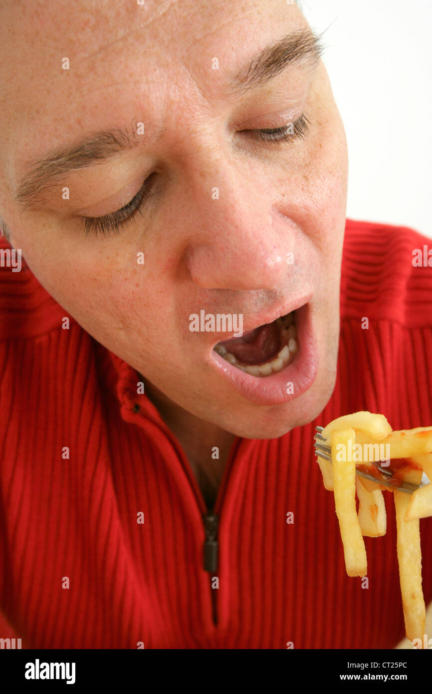 MAN EATING STARCHY FOOD Stock Photo - Alamy