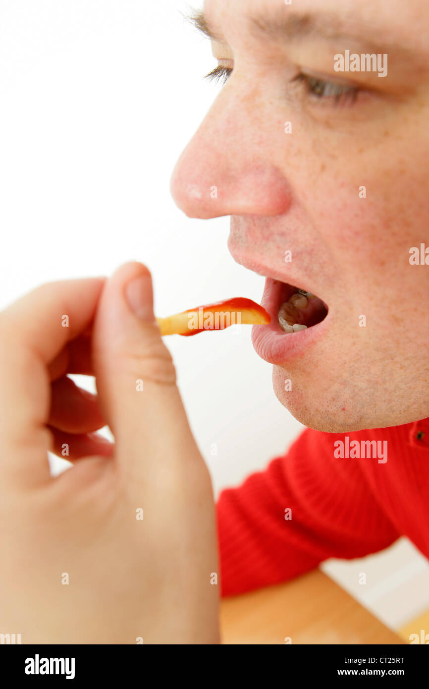 MAN EATING STARCHY FOOD Stock Photo - Alamy