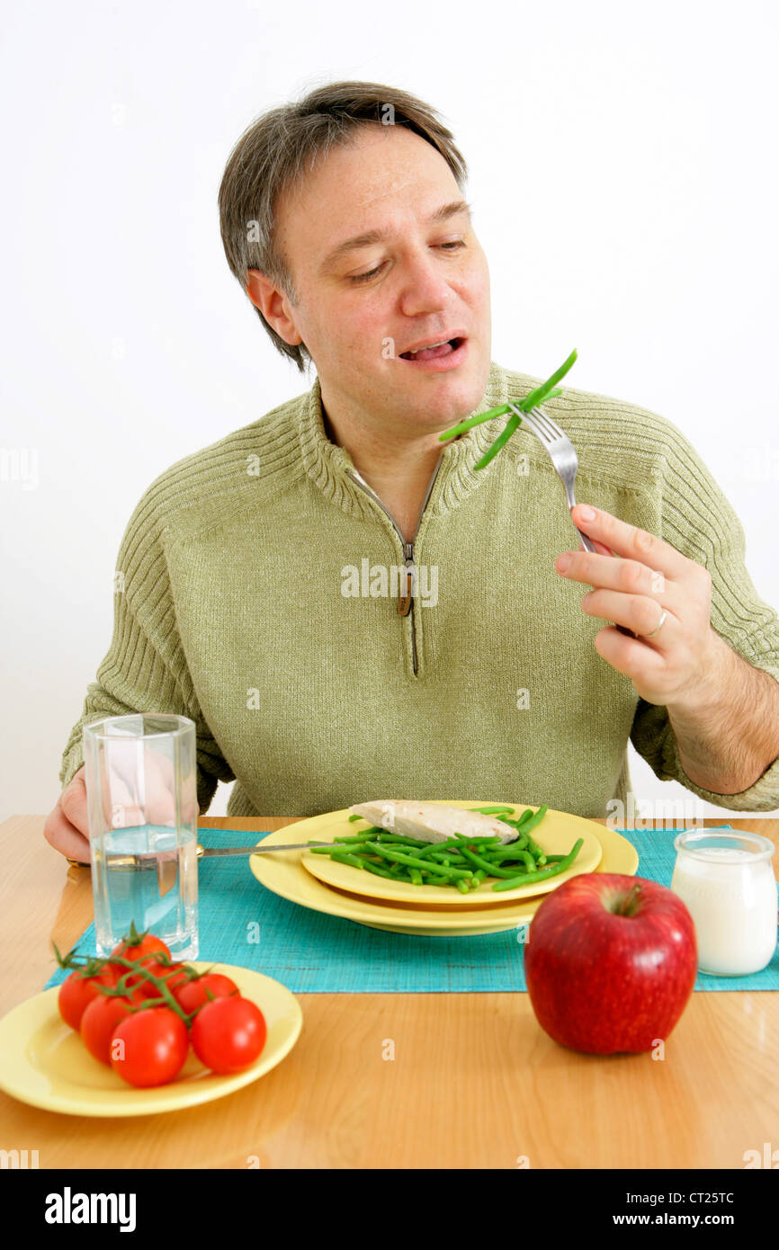 MAN EATING MEAT Stock Photo - Alamy
