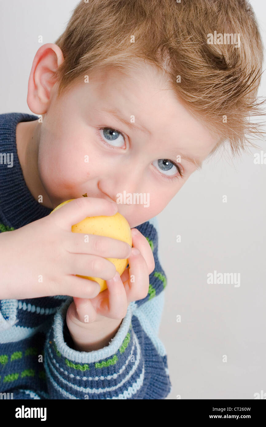 CHILD EATING FRUIT Stock Photo - Alamy