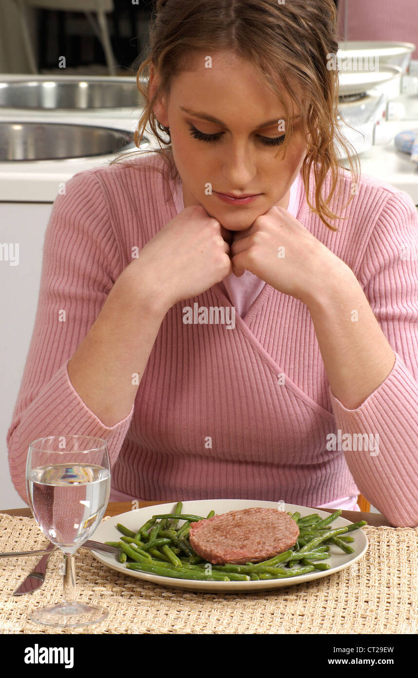 WOMAN EATING MEAT Stock Photo - Alamy