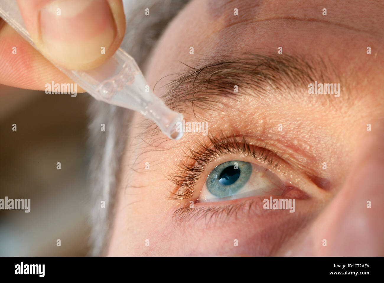 MAN USING EYE LOTION Stock Photo - Alamy