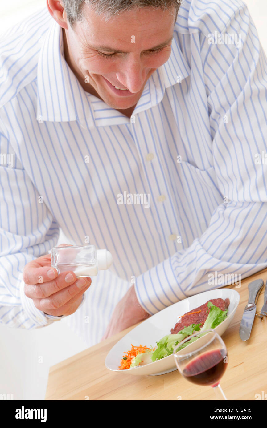 MAN EATING MEAT Stock Photo - Alamy