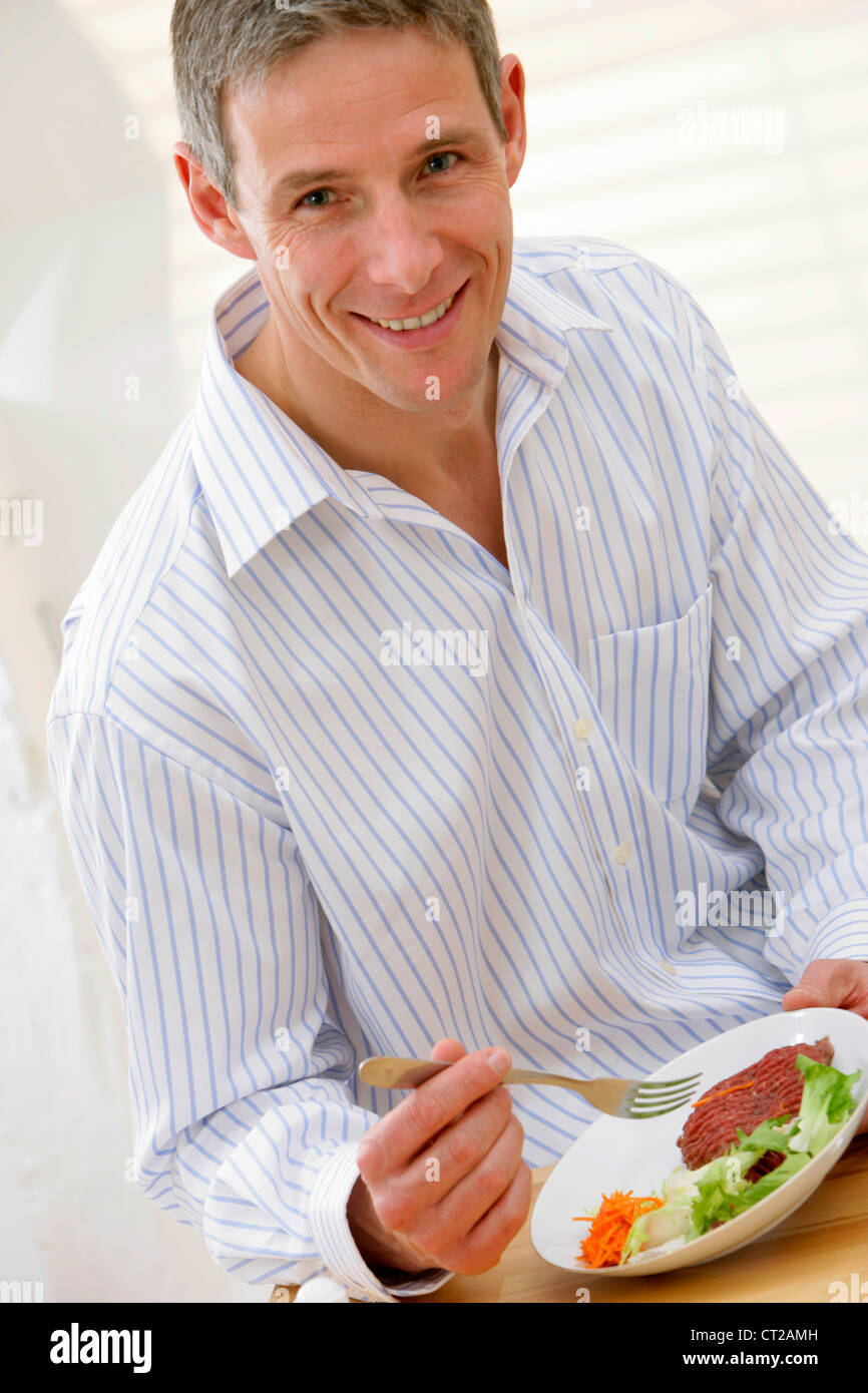MAN EATING MEAT Stock Photo - Alamy