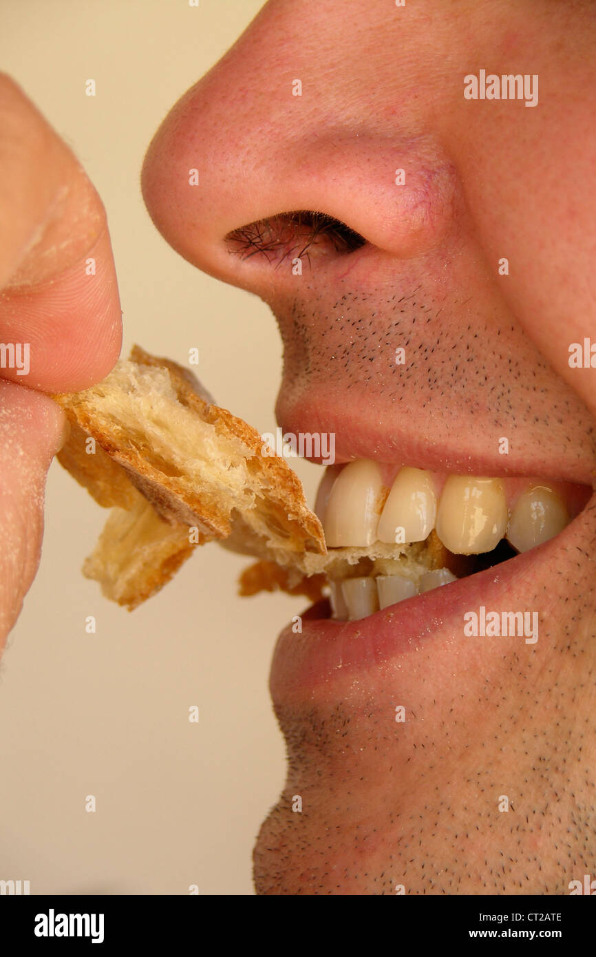 MAN EATING STARCHY FOOD Stock Photo - Alamy