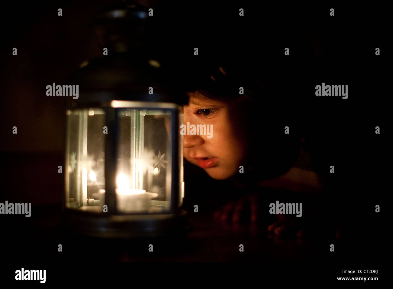 Three year old boy looking a candle Stock Photo - Alamy