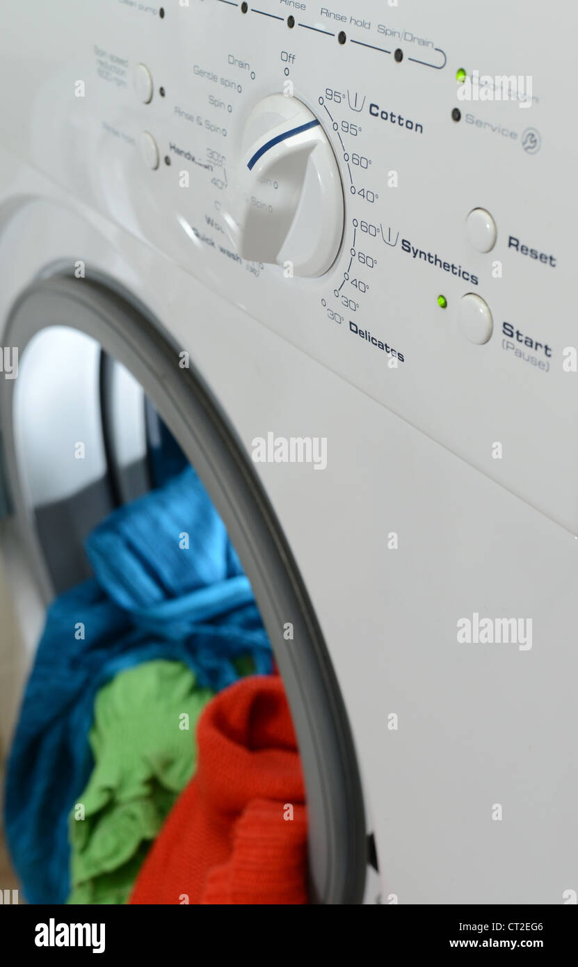 Bright washing in washing machine drum Stock Photo - Alamy