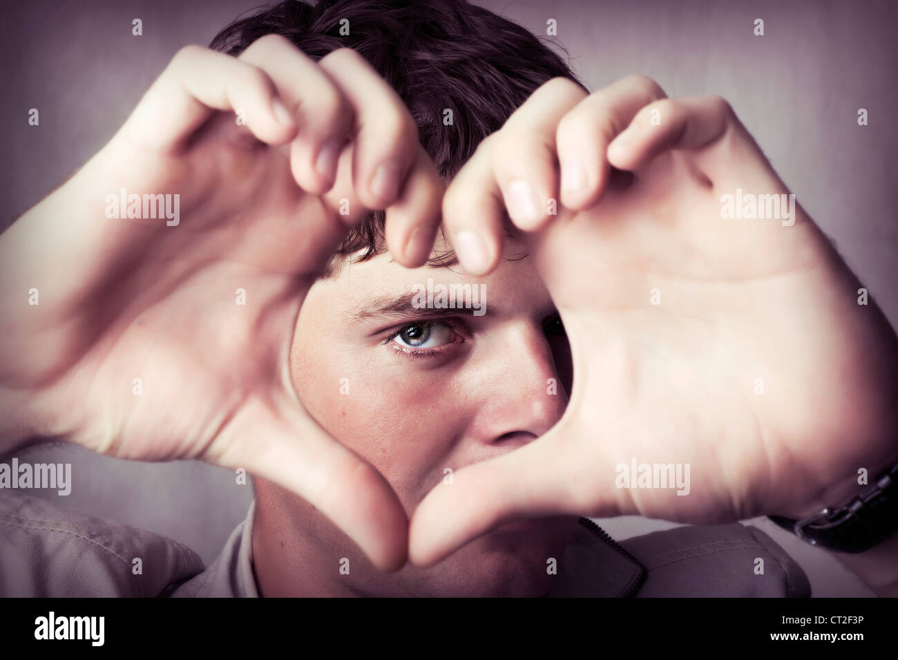 Beautiful young man show love sign Stock Photo - Alamy